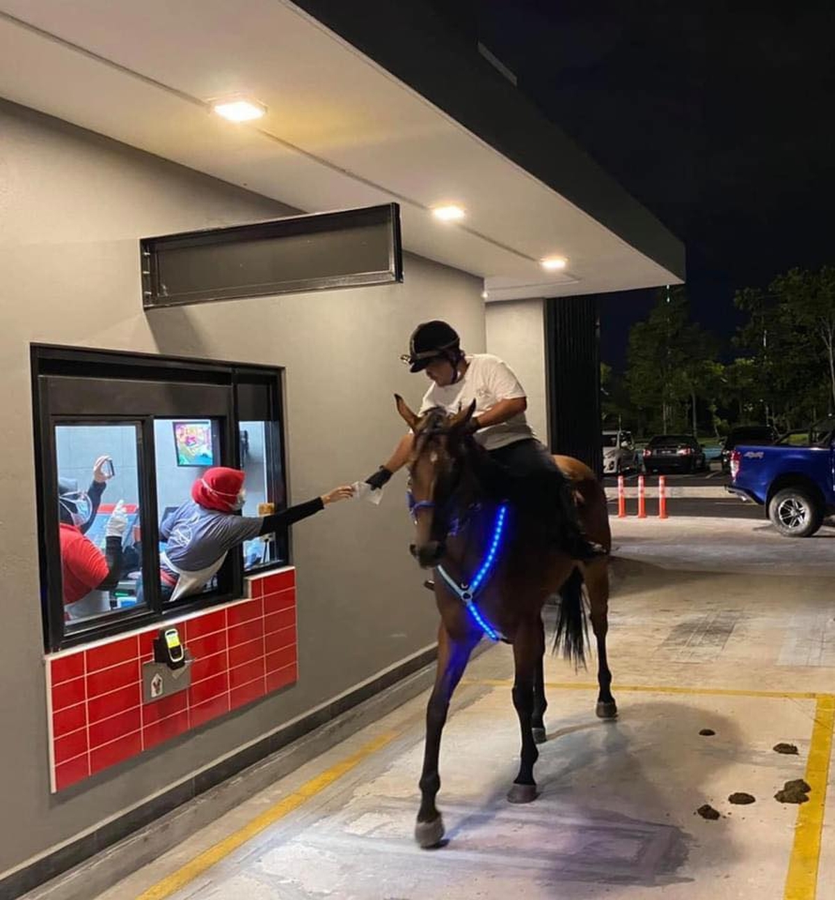 Why are people riding horses through a McDonald's drive-through?